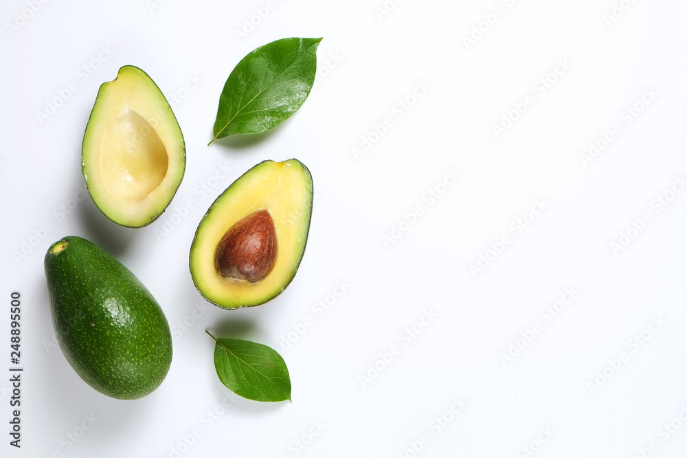 Minimal composition with whole and halved nutrient dense avocado fruit ...