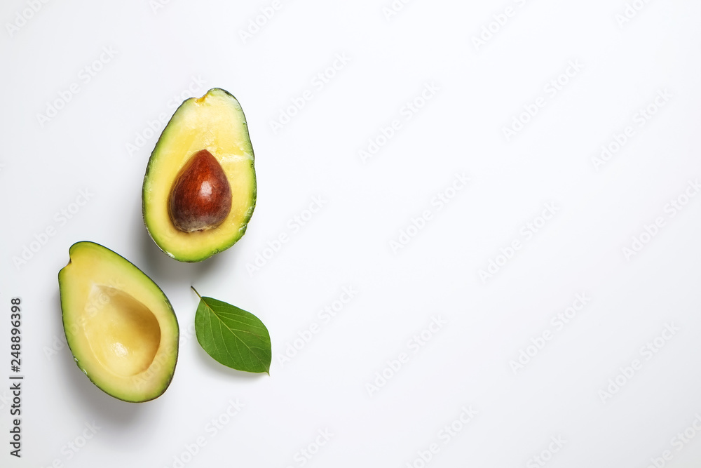 Minimal composition with leaf and halved nutrient dense avocado fruit ...