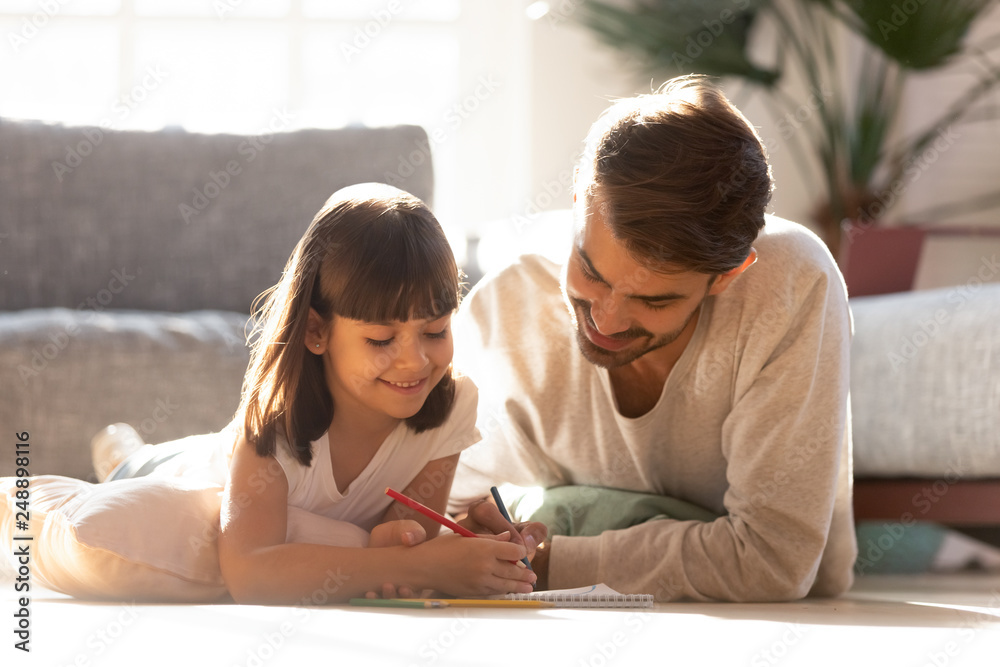Caring dad and kid daughter enjoy drawing with colored pencils Stock ...