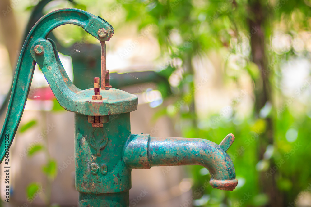 Old manual water pump (Lever pump). Vintage cast iron water pump with ...