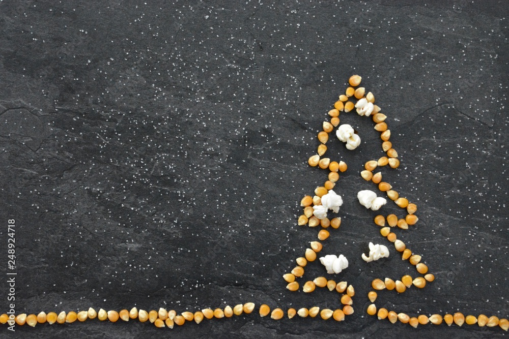 Popcorn corn shapes a Christmas tree on a dark background with ...