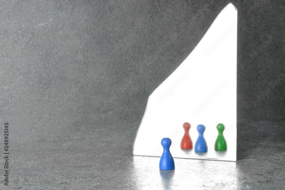 A single character stands in front of a mirror and in the mirror image ...