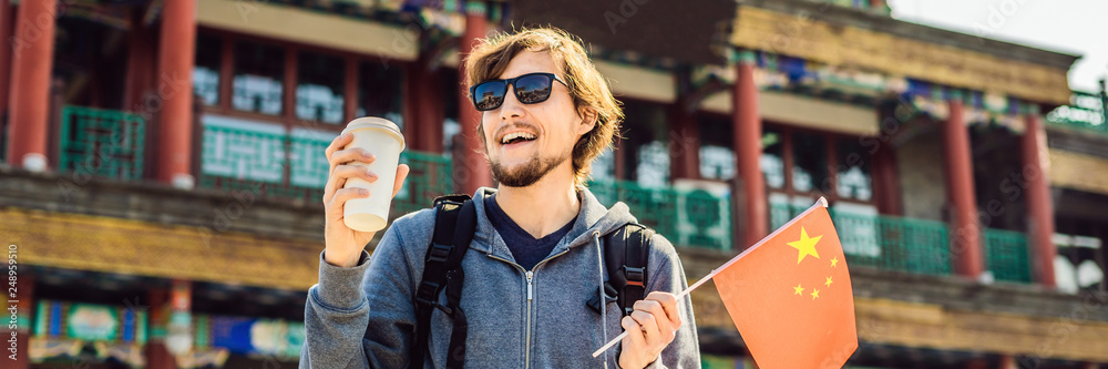 Enjoying vacation in China. Young man with national chinese flag on the ...