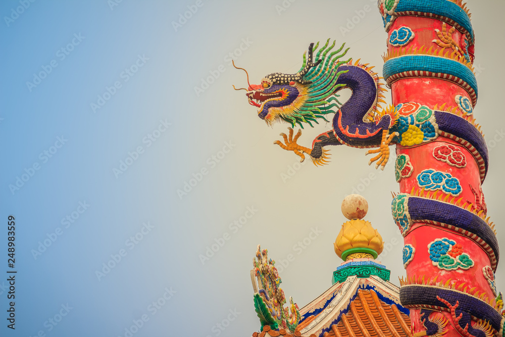 Colorful statue of Chinese dragon wrapped around red pillar. Beautiful ...