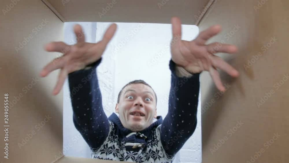 Vidéo Stock Funny man opens a parcel box with different versions of ...