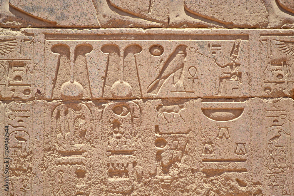 Egyptian hieroglyphs, symbols and signs on a stone wall in Karnak ...