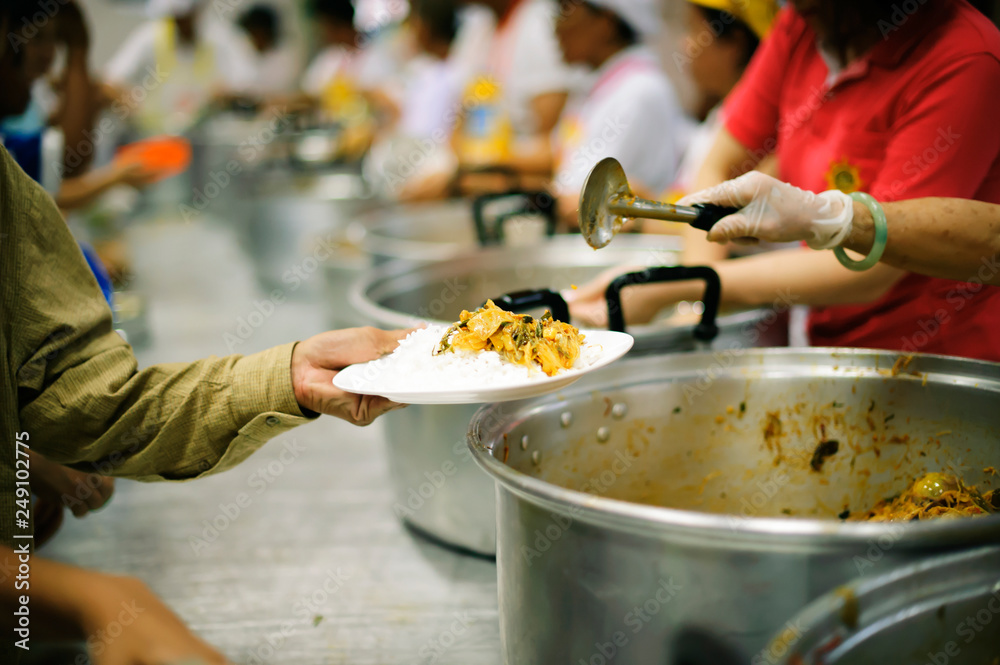 volunteers give food to local poor people, the villagers gladly accept ...