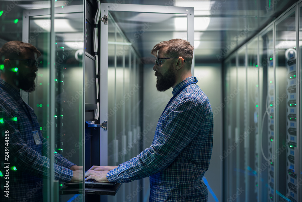 Bearded IT specialist setting servers in data center Stock Photo ...