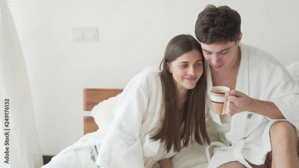 Girl and boy/couple, lovers are lying on the bed, kissing each other on ...