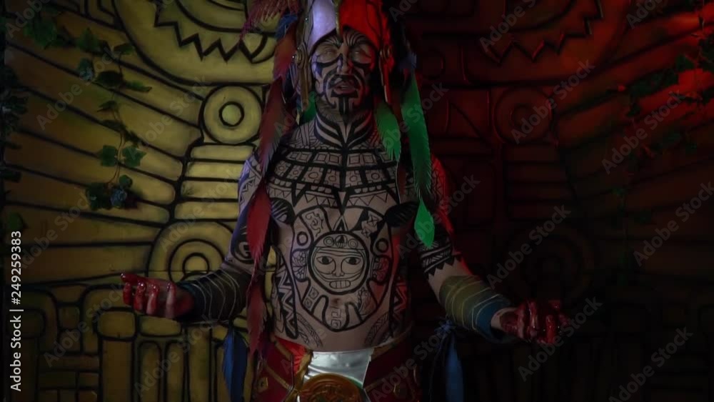 Tribal shaman at the sacrifice place, holding a heart in his hand and ...