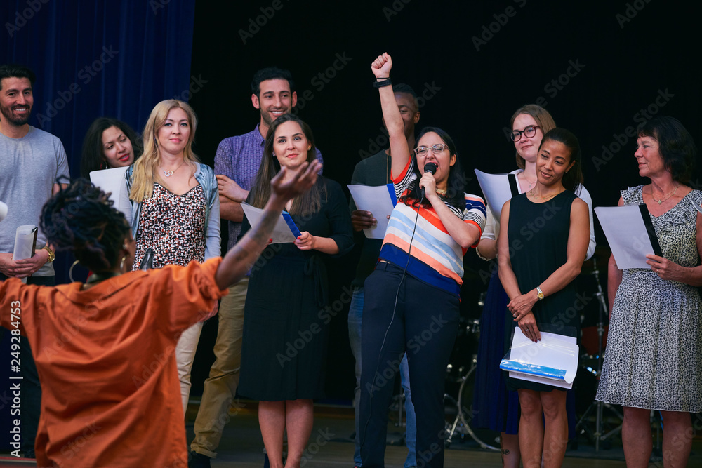 Choir singer with friends performing on stage in auditorium Stock Photo ...
