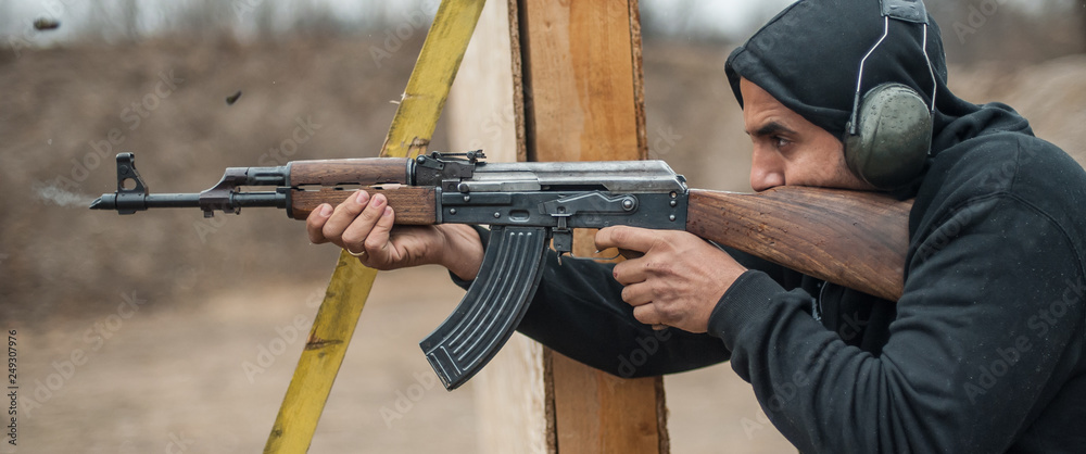 Combat riffle machine gun shooting from behind cover or barricade Stock ...