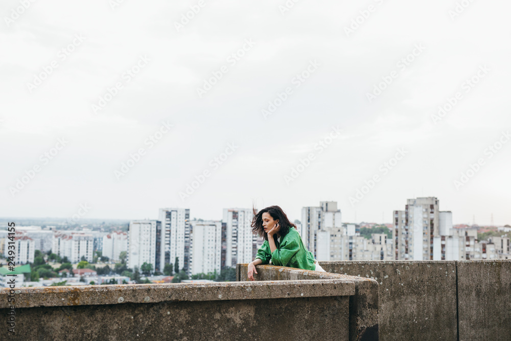 Beautiful urban woman fashion model posing on a rooftop. Stock Photo ...