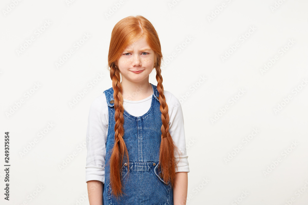 Portrait of emotional kid looks sad, displeased, expresses offense ...