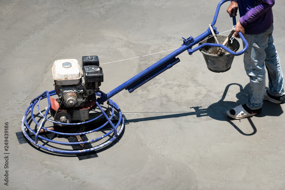 Steel trowel machine for smoothing surface to finish of concrete slab ...