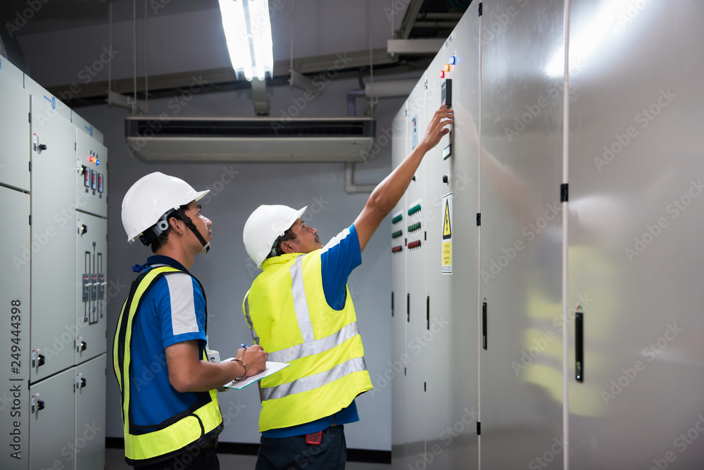 Electrical engineering with inspector while training and recording in ...