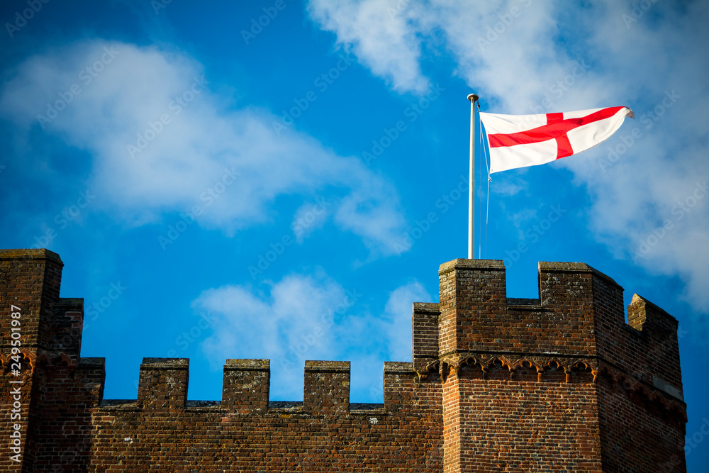 England flag flying above castle fortifications with blue sky Stock ...