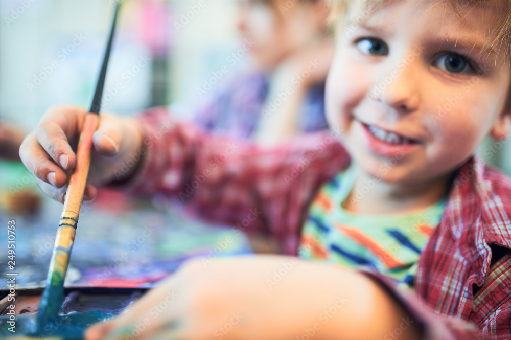 Cute happy little boy and teacher drawing in artist class. Education ...