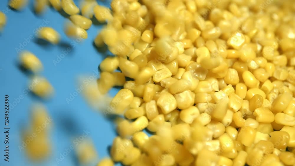 Canned corn kernels on brown wooden background. Slow motion. 1. Canned ...