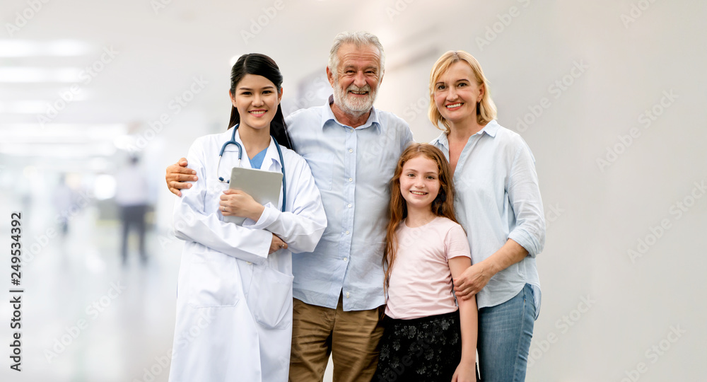 Doctor with happy family of mother, father and daughter at the hospital ...