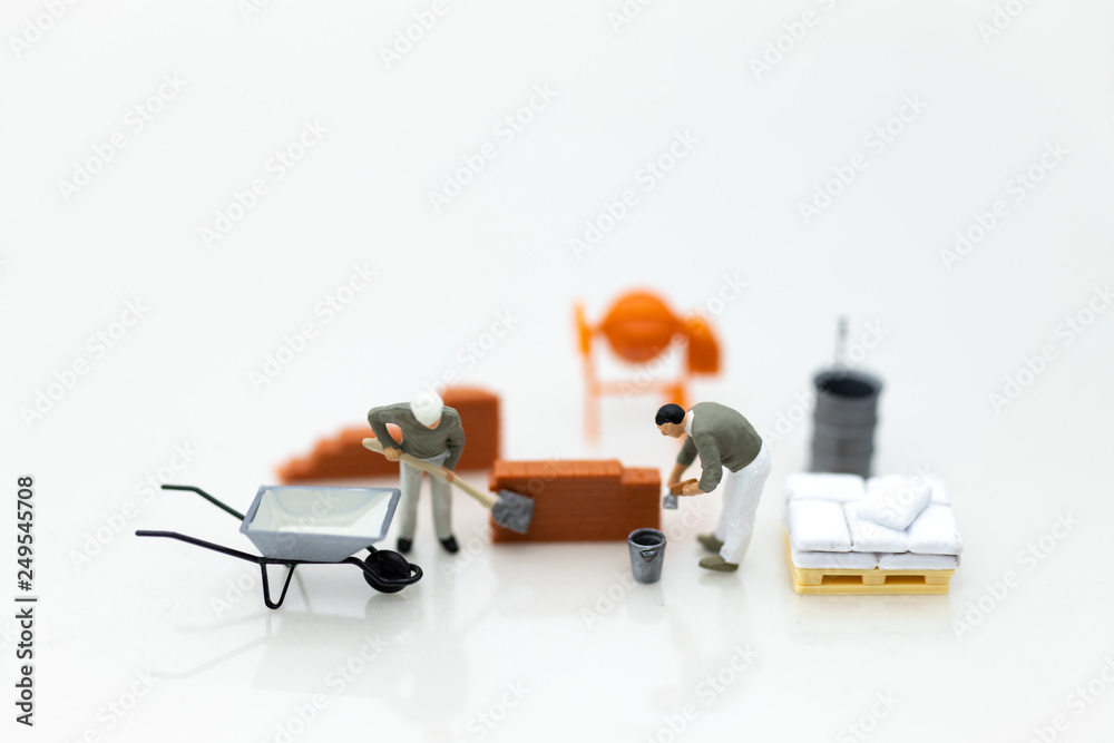 Miniature people: Construction workers building plans , have building ...