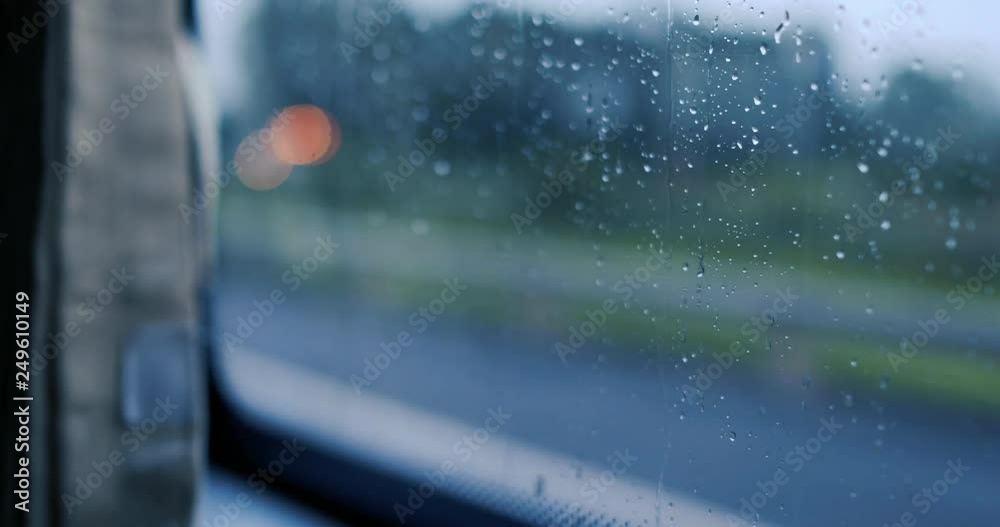 Raindrops on glass car window with road light bokeh. Royalty high ...