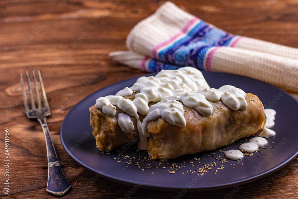 Hot cabbage rolls with rice, meat with sour cream in a clay dish. Kelem ...