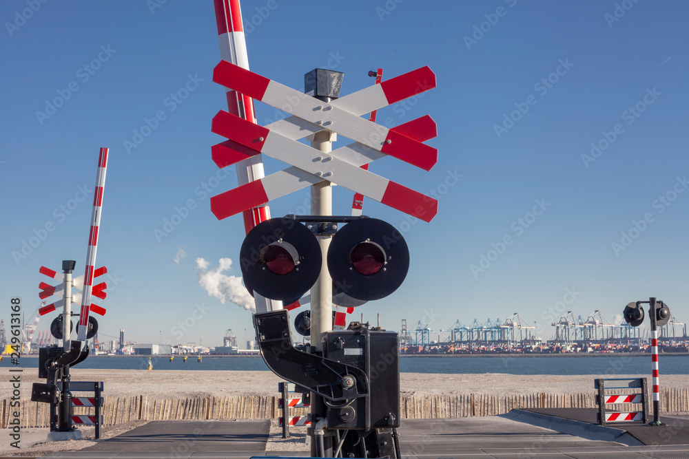 Port of rotterdam. Road signs at the railway crossing with a barrier ...
