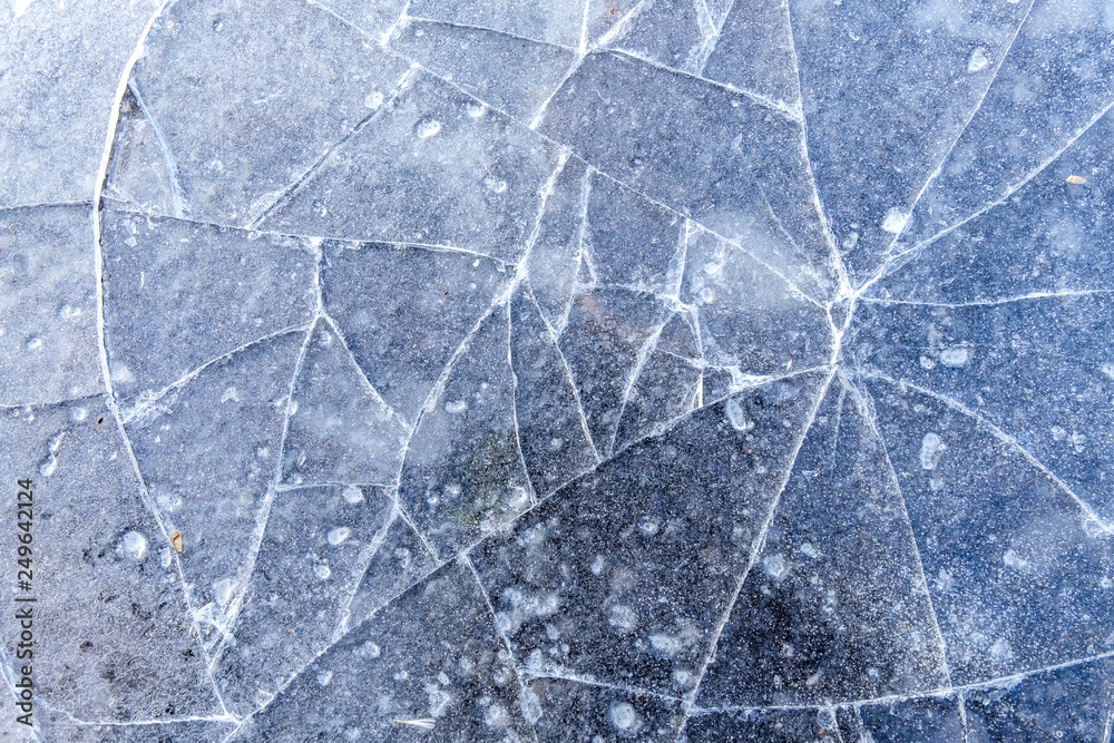 thin layer of ice on the pond surface with cracks texture background ...