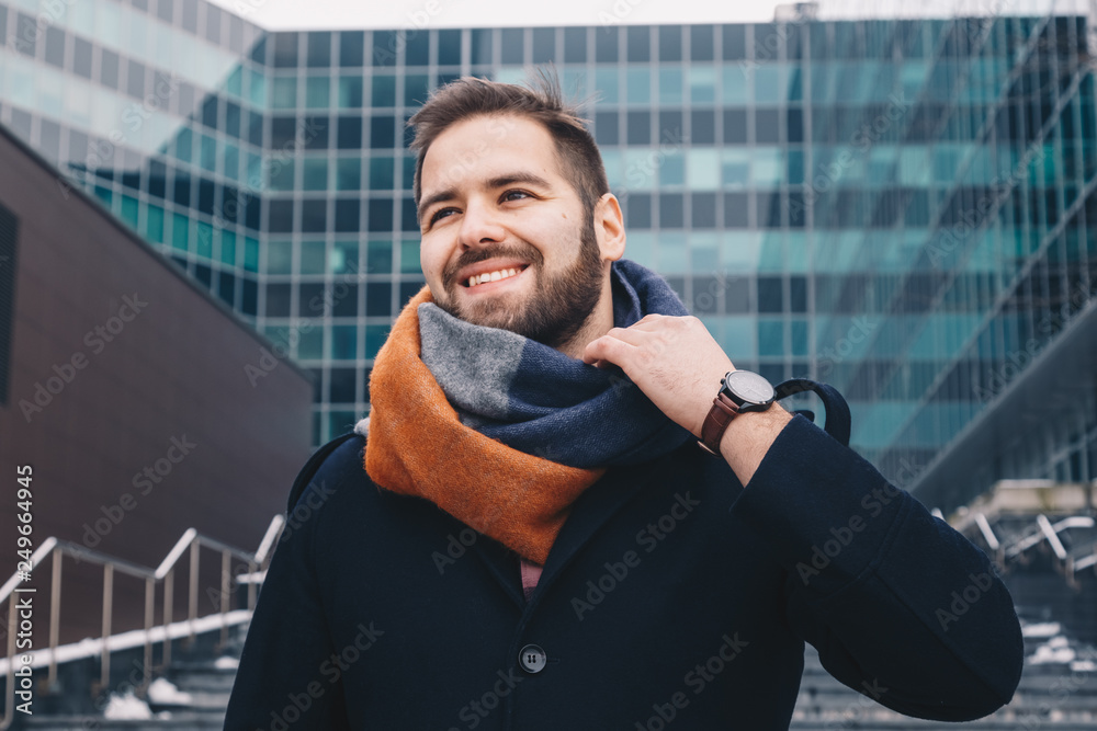 Portrait of a successful and gashionable man posing in front of a ...