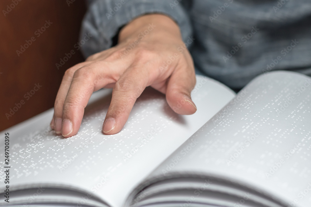 Braille book with visual impaired, low vision, blind person's hand ...