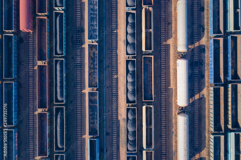 Aerial view of colorful freight trains on the railway station. Wagons ...