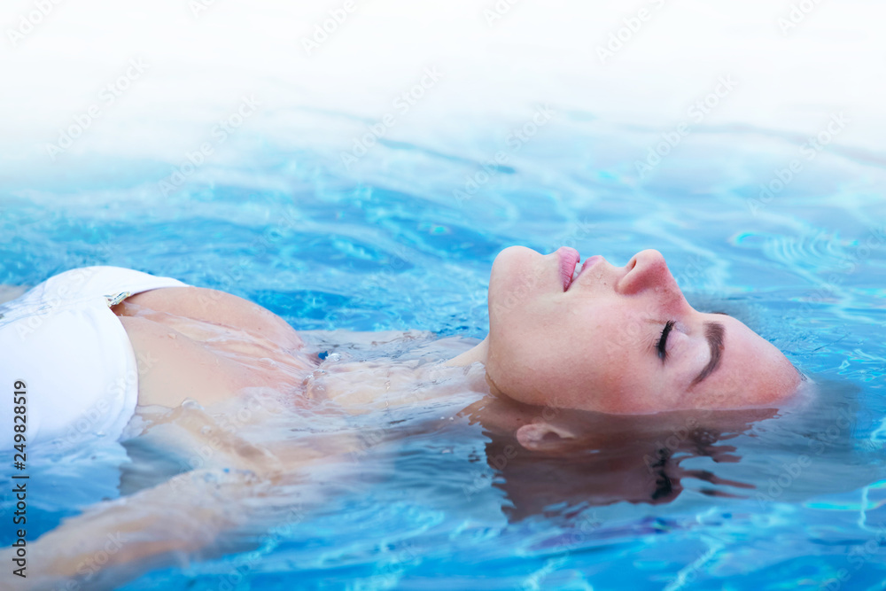 Girl relaxing in swimming pool Stock Photo | Adobe Stock