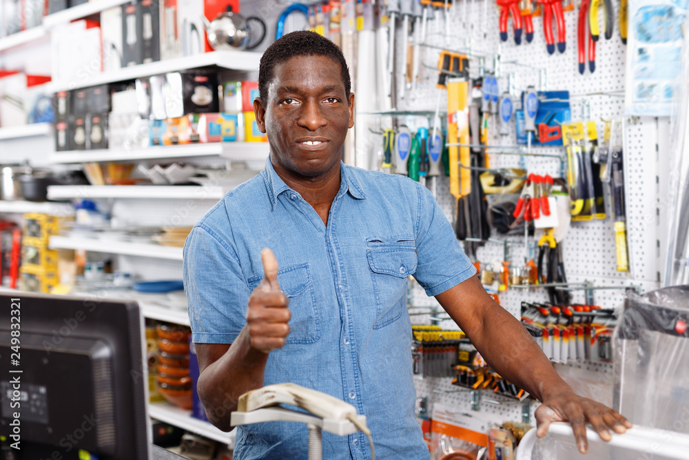 Portrait of happy successful owner of household goods store standing ...