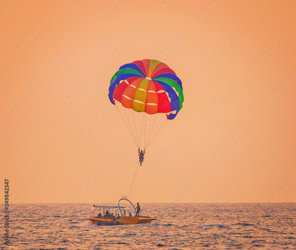 Parasailing on Baga Beach, Goa in summer. person under parachute ...