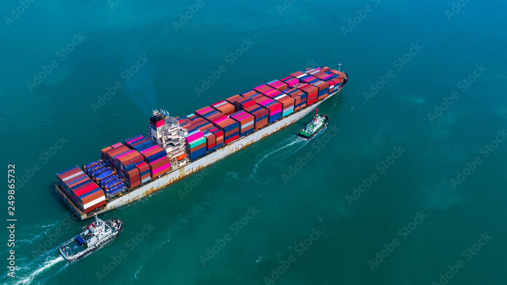 Container ship arriving in port, container ship and tug boat going to ...