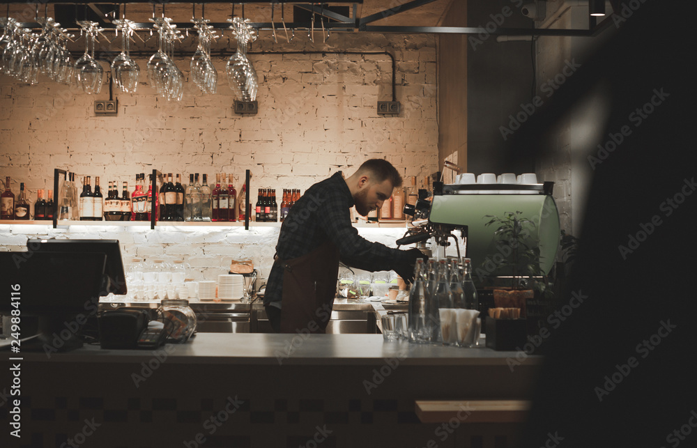 Barista at the restaurant bar counter.Portrait of a bartender with a ...