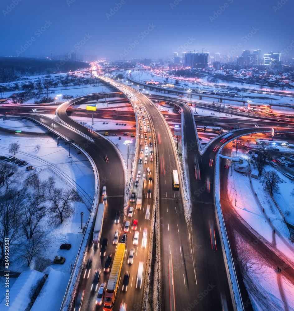 Aerial view of the road in modern city at night in fog. Top view of ...