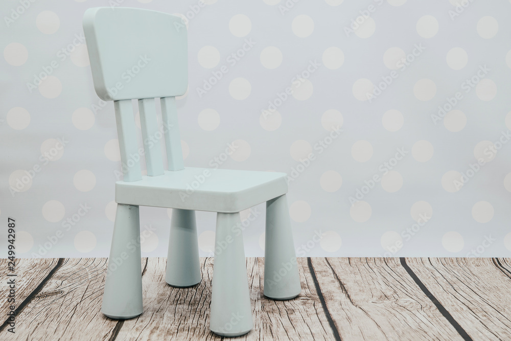 Blue pastel chair on a pastel background side view. Pastel colors. Baby ...