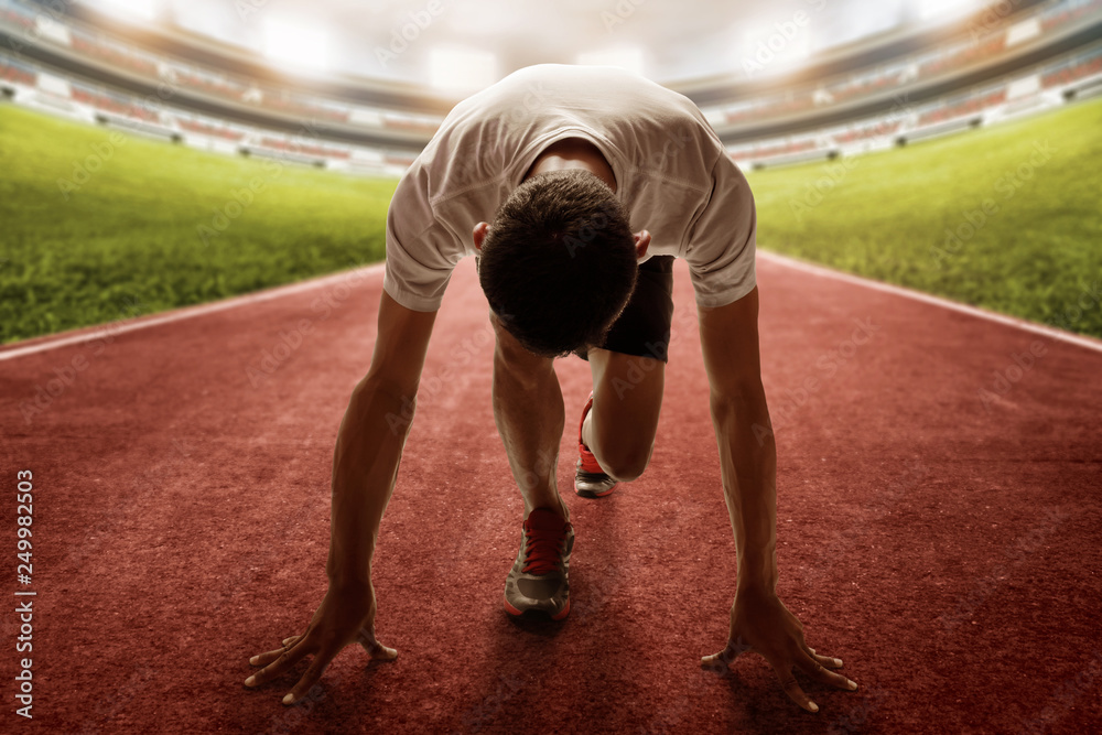 Athlete in starting position Stock Photo | Adobe Stock