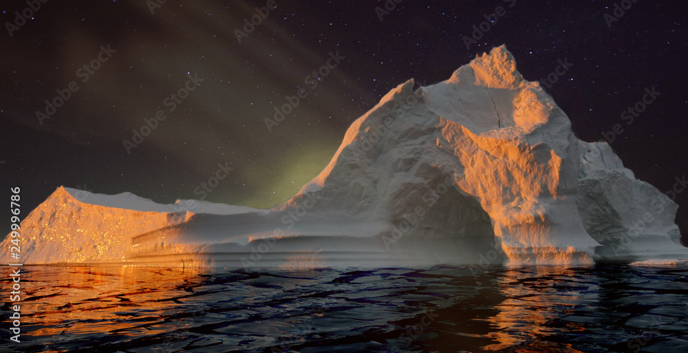 Iceberg with cave at night. Elements of this image furnished by NASA ...