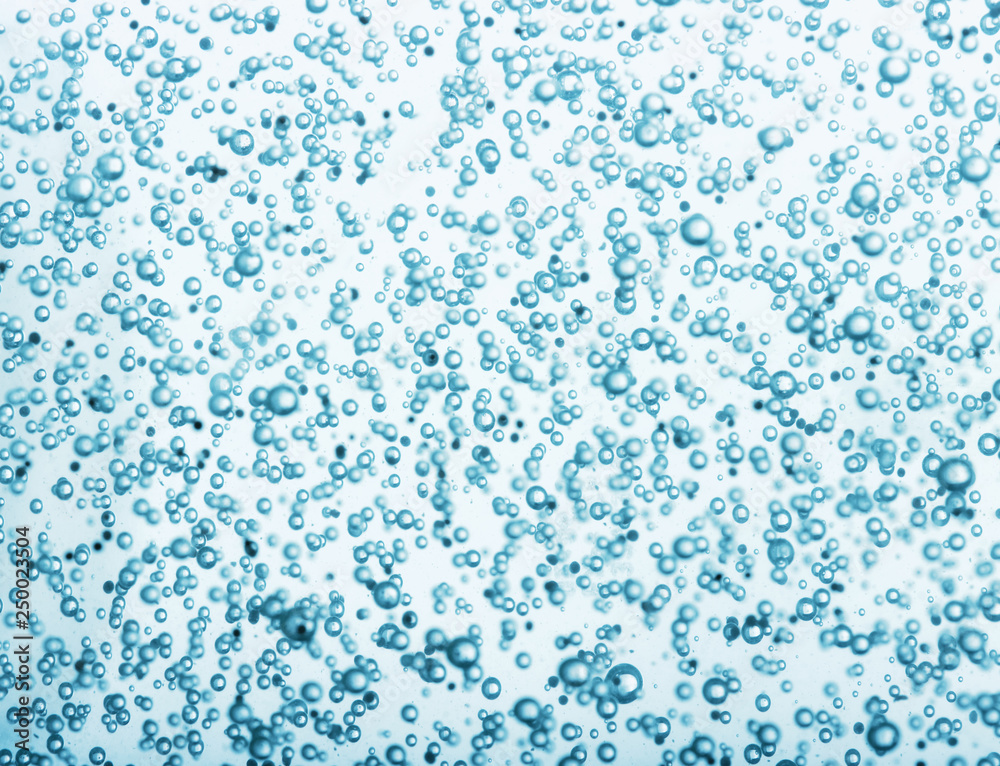 Oxygen bubbles in clear blue water, close-up. Mineral water. Water ...