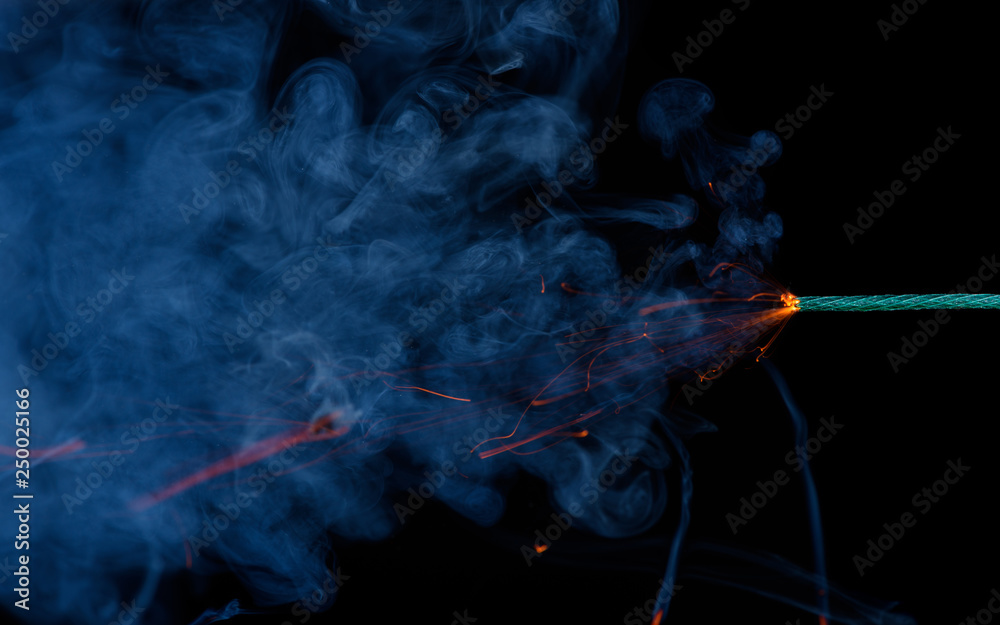 Firecracker firework fuse burning with smoke and sparkles on black ...