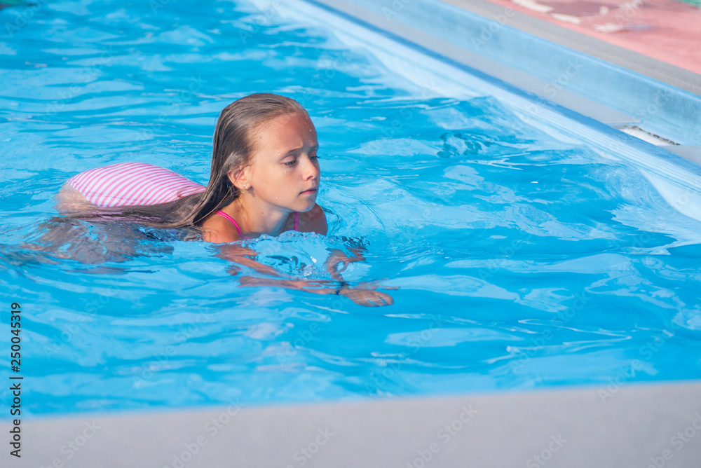 Beautiful little girl swims in the pool , cute little girl in pool in sunny day. Stock Photo ...