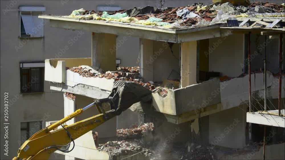 Video Stock Building under deconstruction with heavy machinery. 4K ...