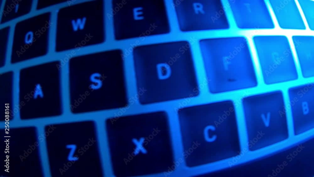 A computer programmer or hacker prints a code on a laptop keyboard to ...