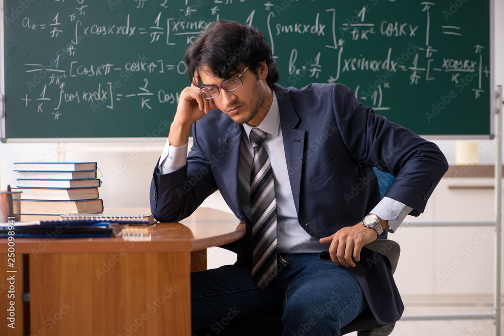 Young male math teacher in classroom Stock Photo | Adobe Stock