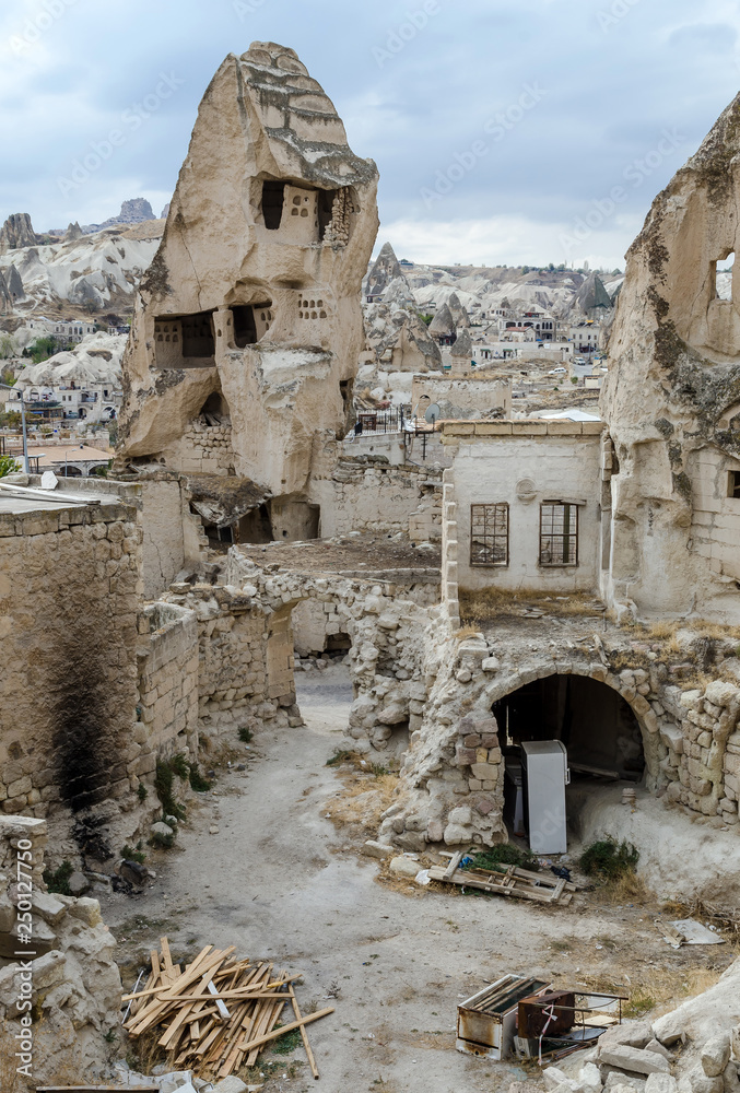 The vertical view of collapsing rock pillar with dovecote cave inside ...