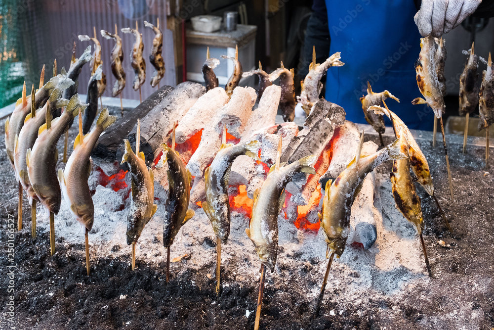 Fish Ayu with salt being charcoal broiled in Japanese grilled fish ...