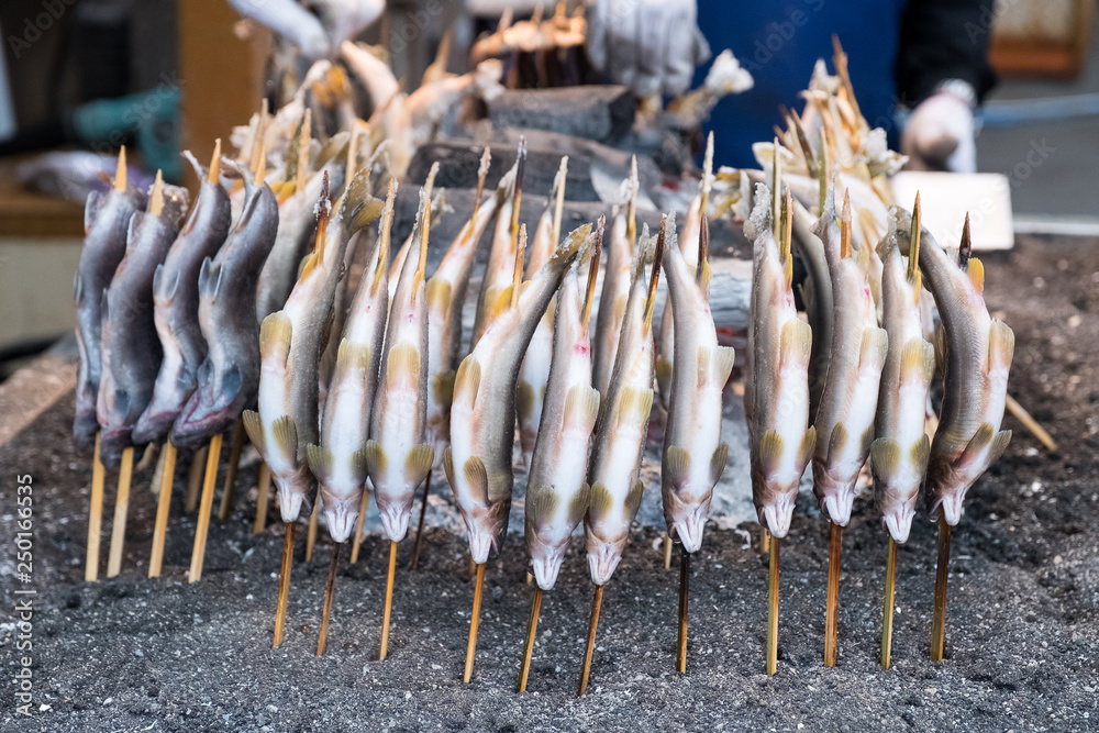 Fish Ayu with salt being charcoal broiled in Japanese grilled fish ...